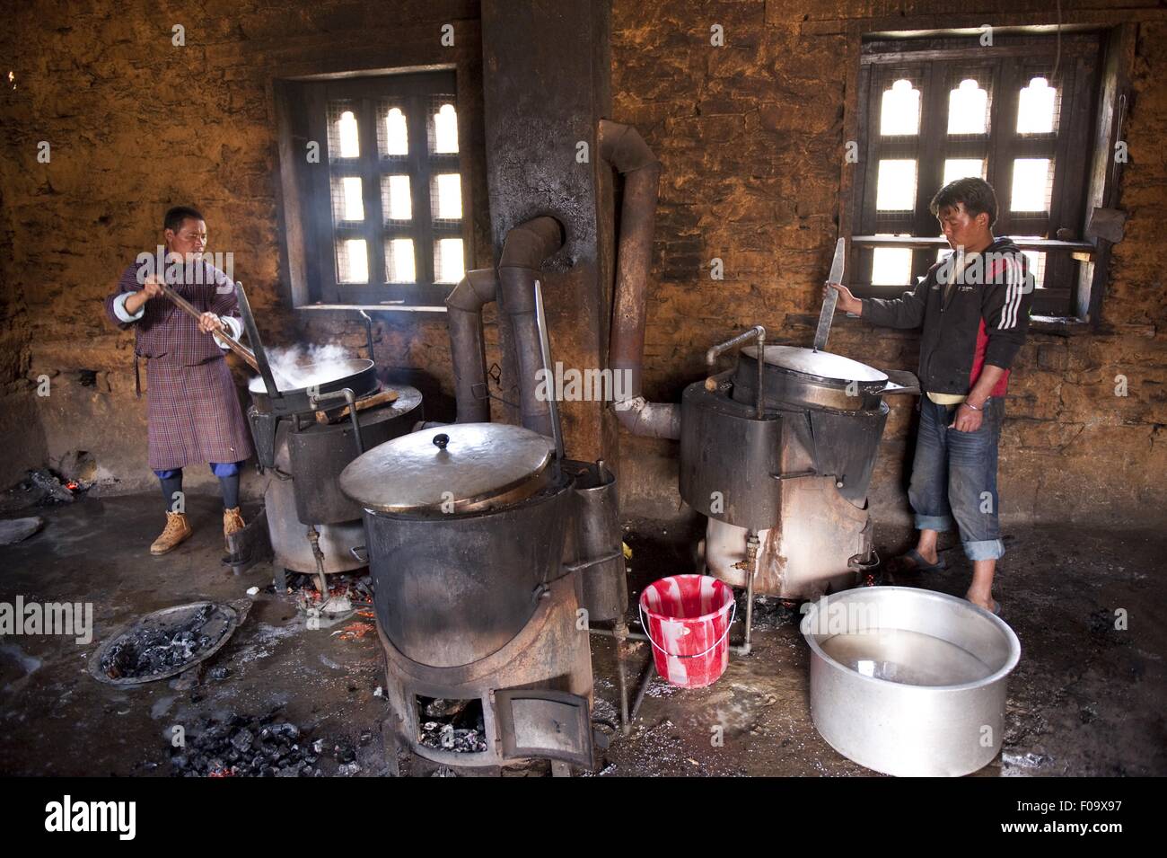 Men cooking rice in kitchen, Bhutan Stock Photo - Alamy