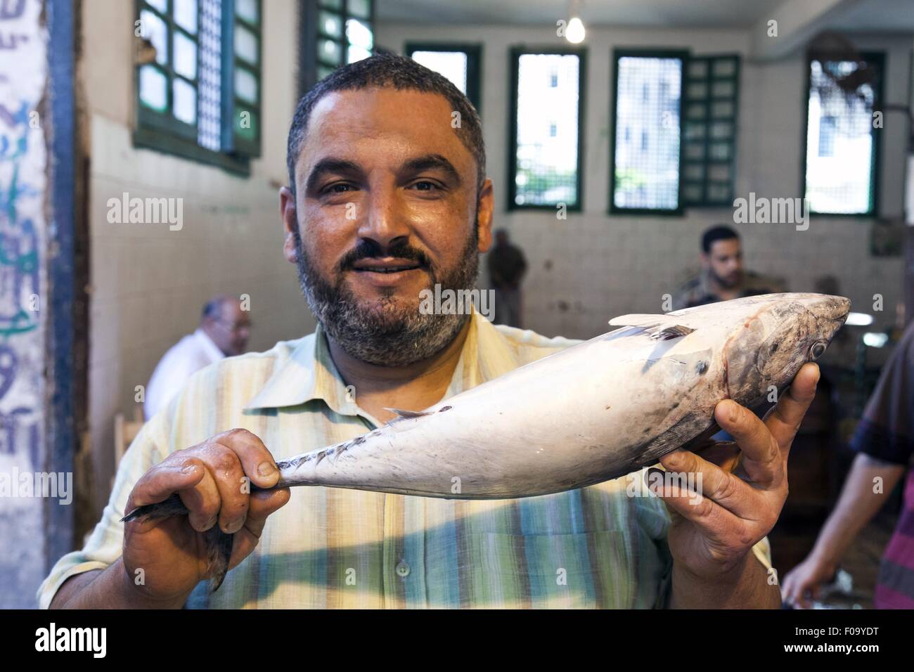 Fisher man holding a fish in Alexandria Fish Market , Alexandria, Egypt ...