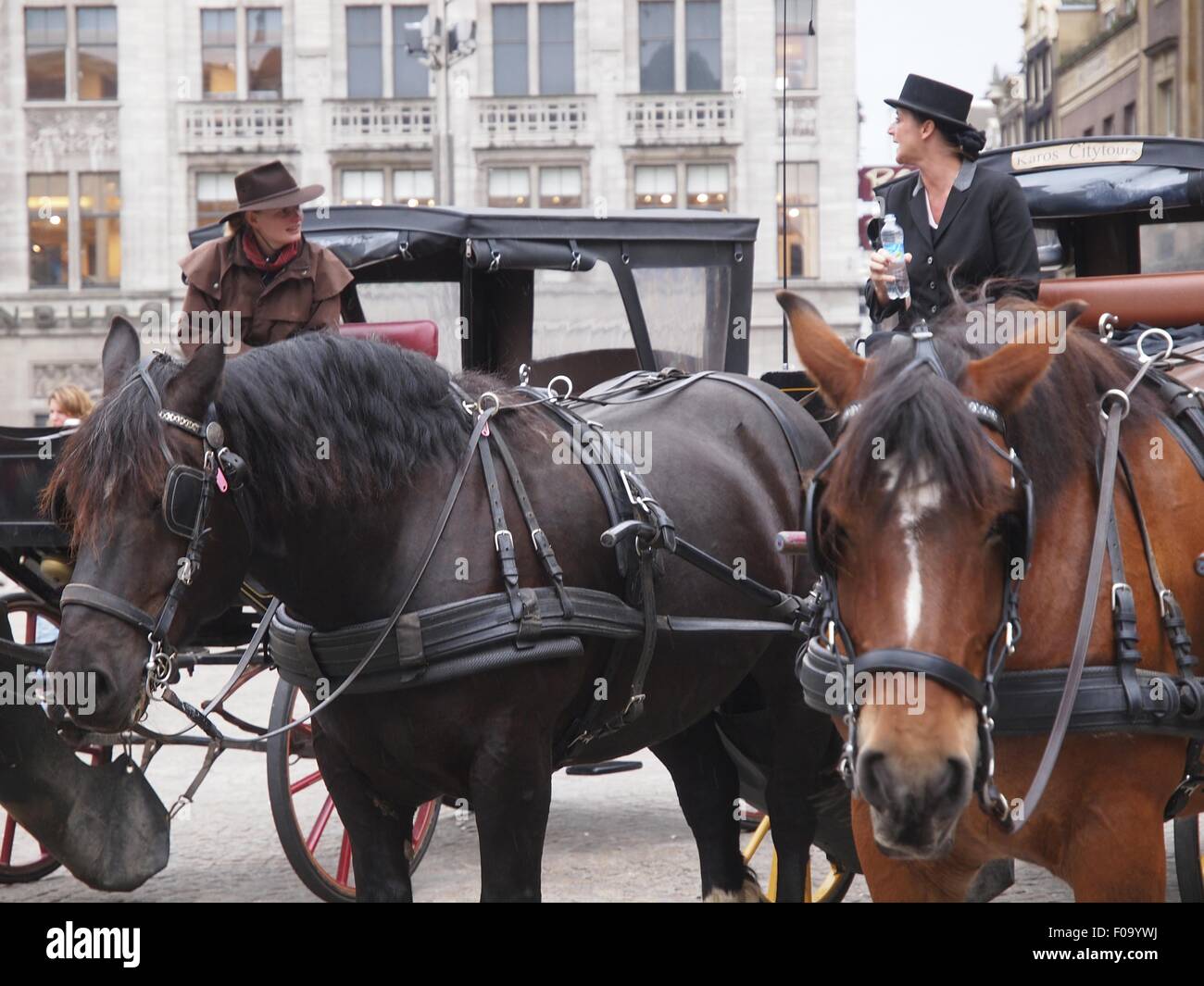 Two women on horse carriages at Dam Square in Karos City tours ...