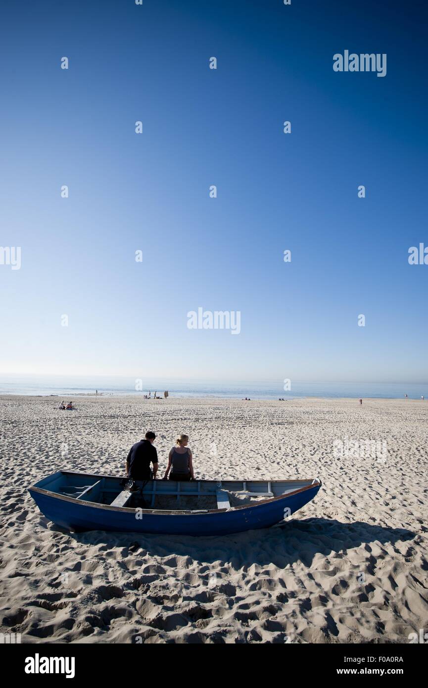 Two people sitting in boat at beach near Kampen, Sylt, Germany Stock ...