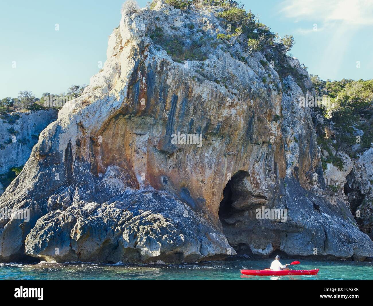 Person kayaking at Grotto in Gulf of Orosei, Sardinia, Italy Stock ...