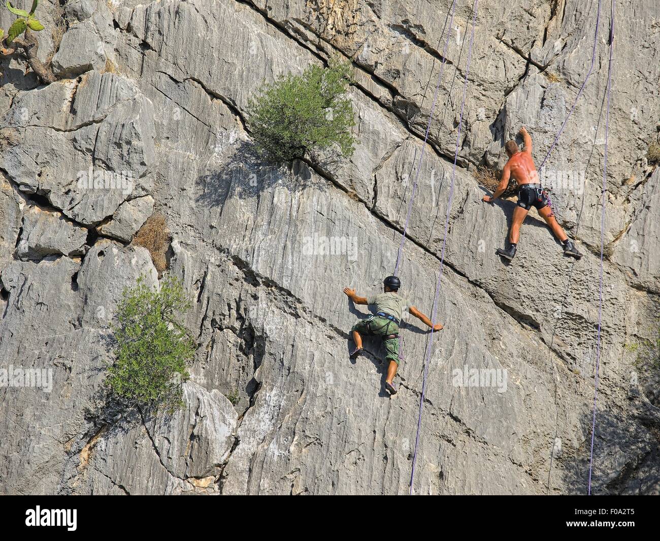 Man climbing rock mountain at Caletta Fuili, Cala Gonone, Sardinia ...
