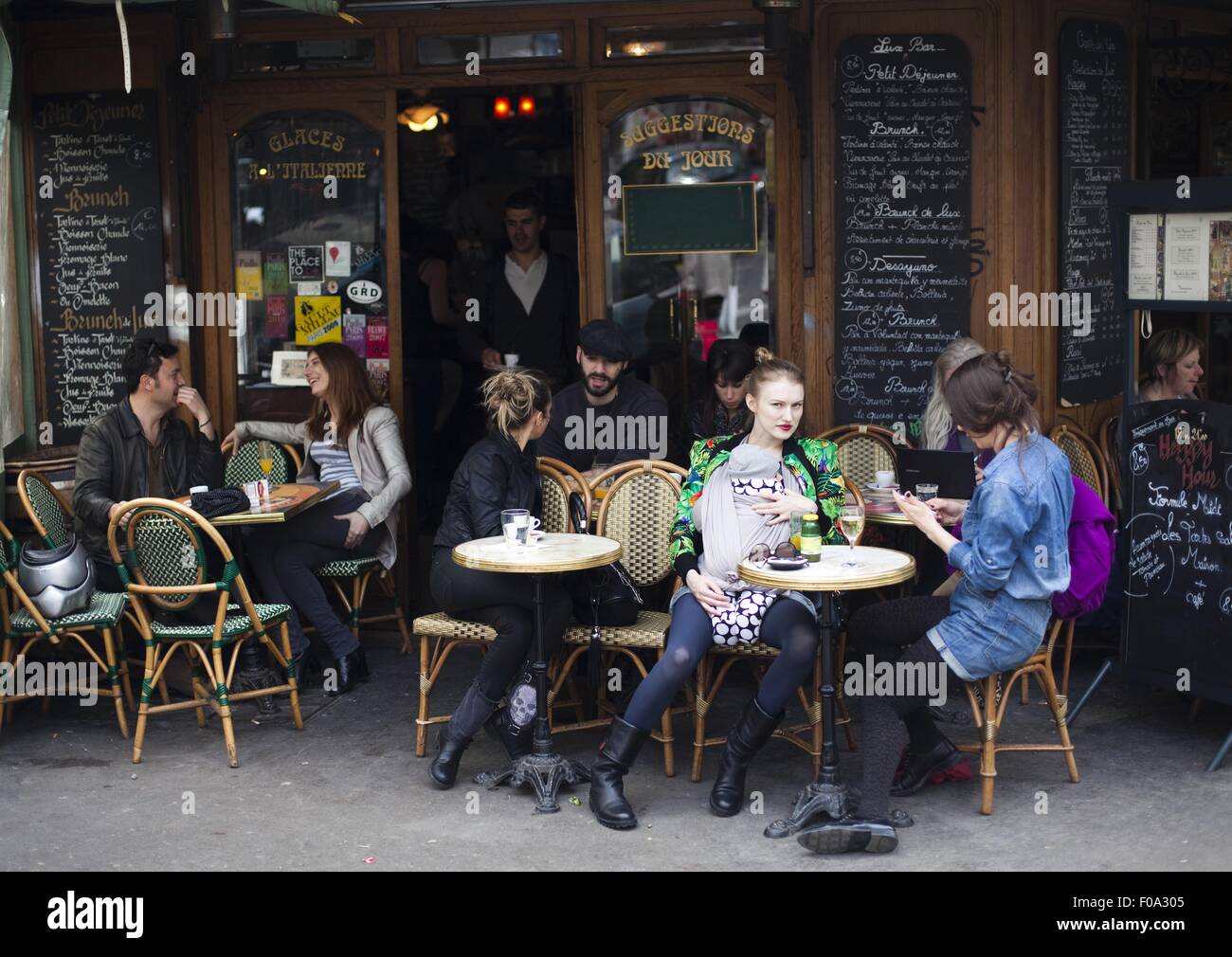People sitting outside French cafe Stock Photo - Alamy