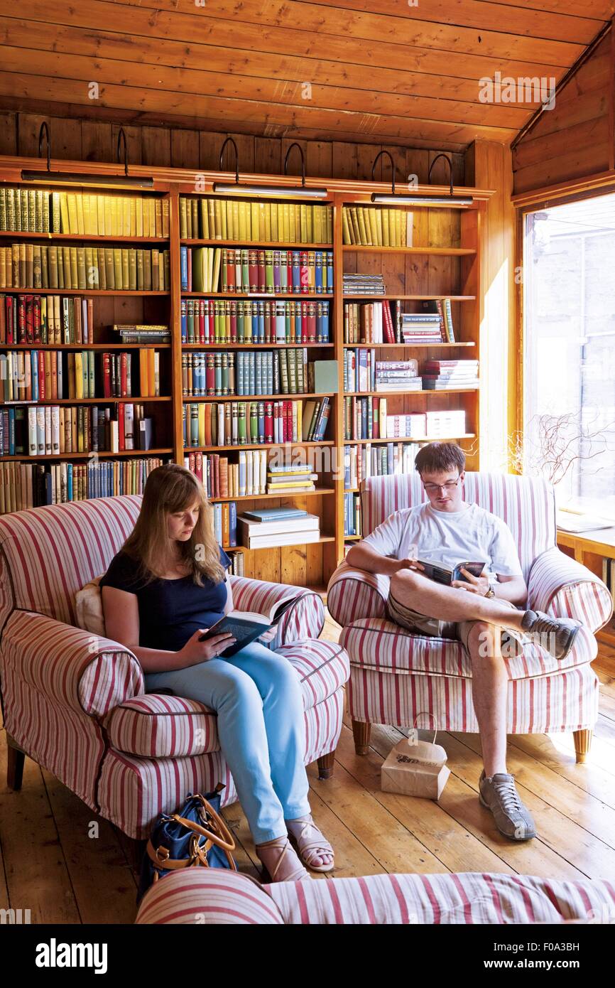 Man And Woman Reading Book At Richard Booths Bookshop In Hay On Wye