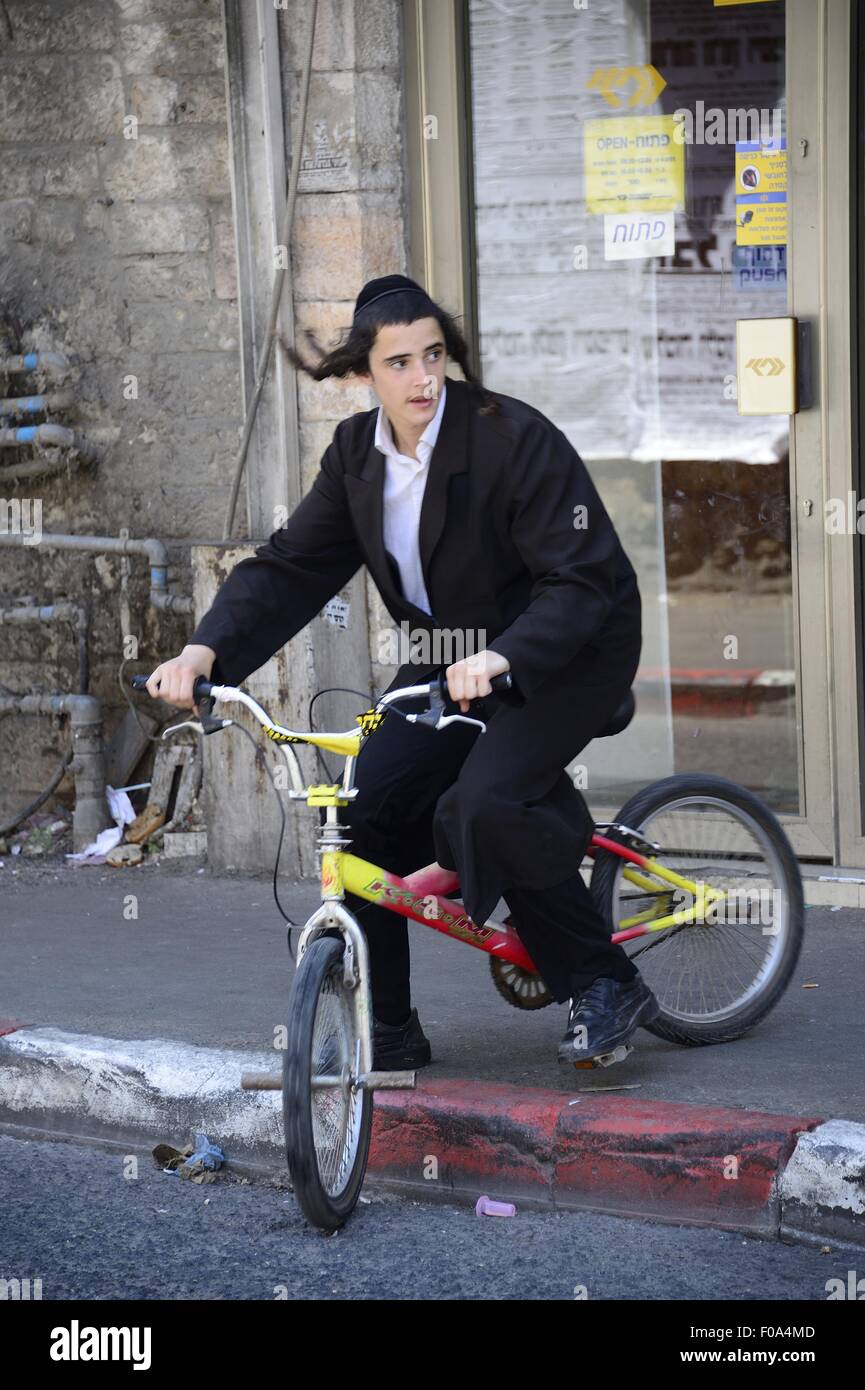 Haredi man riding bicycle on street at Mea Shearim, Jerusalem, Israel ...