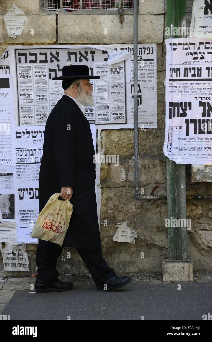 Side view of Haredi man walking on street at Mea Shearim, Jerusalem ...