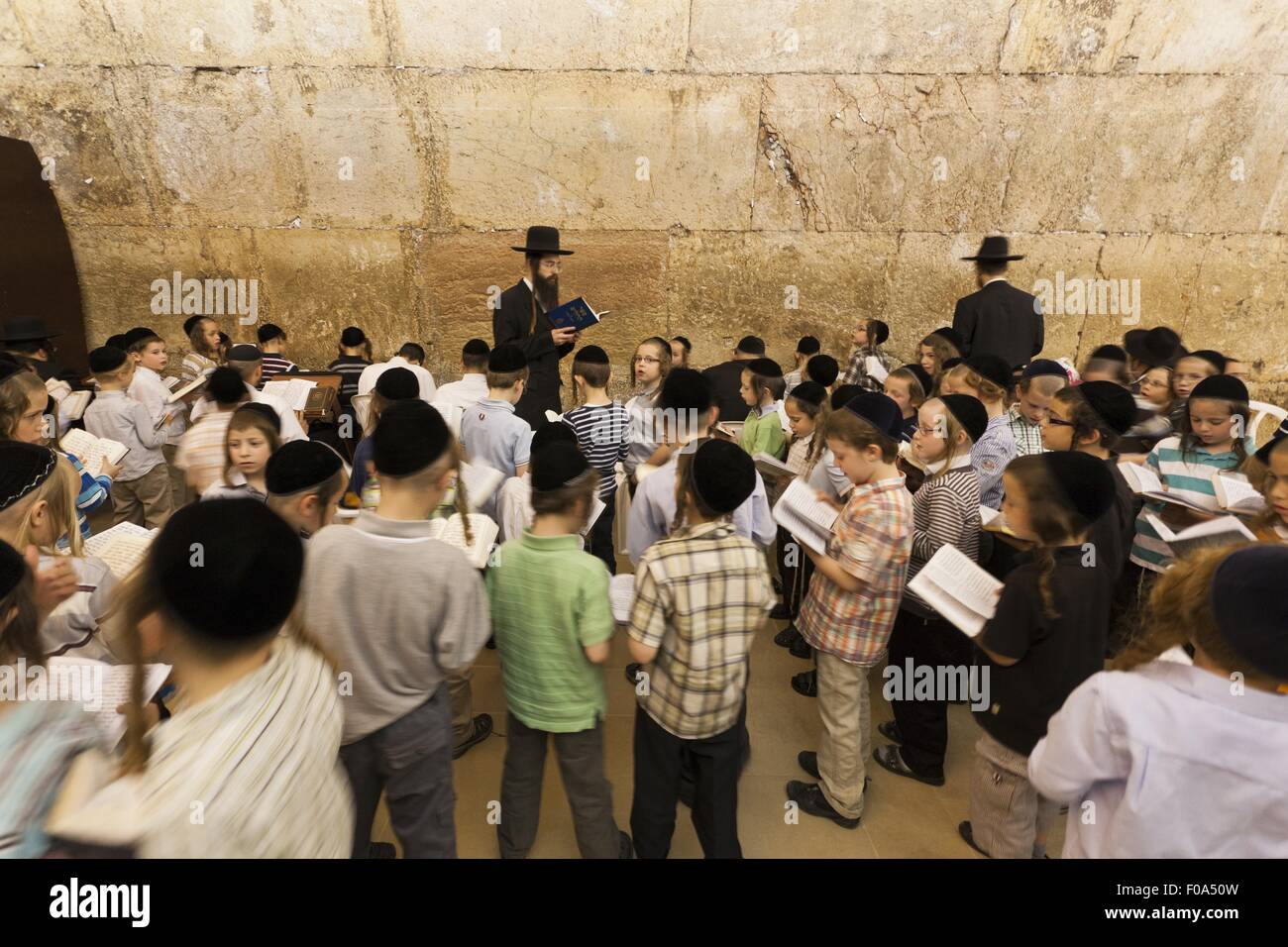 Children and Haredi men reading books at Western Wall, Jerusalem ...