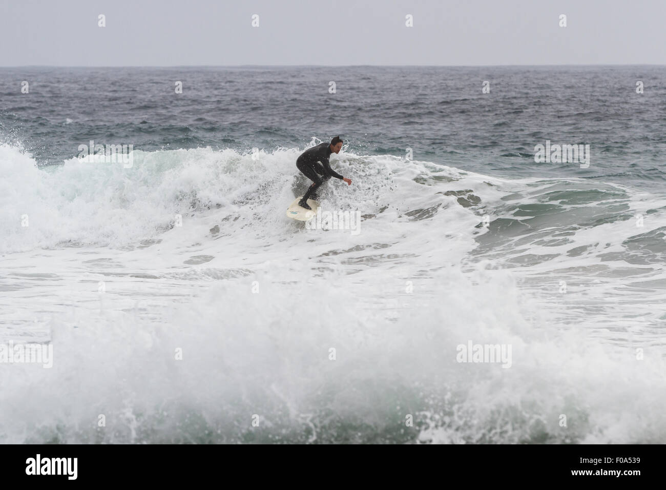Pfeiffer Beach, California - May 01 : Male surfer in a full suit ...