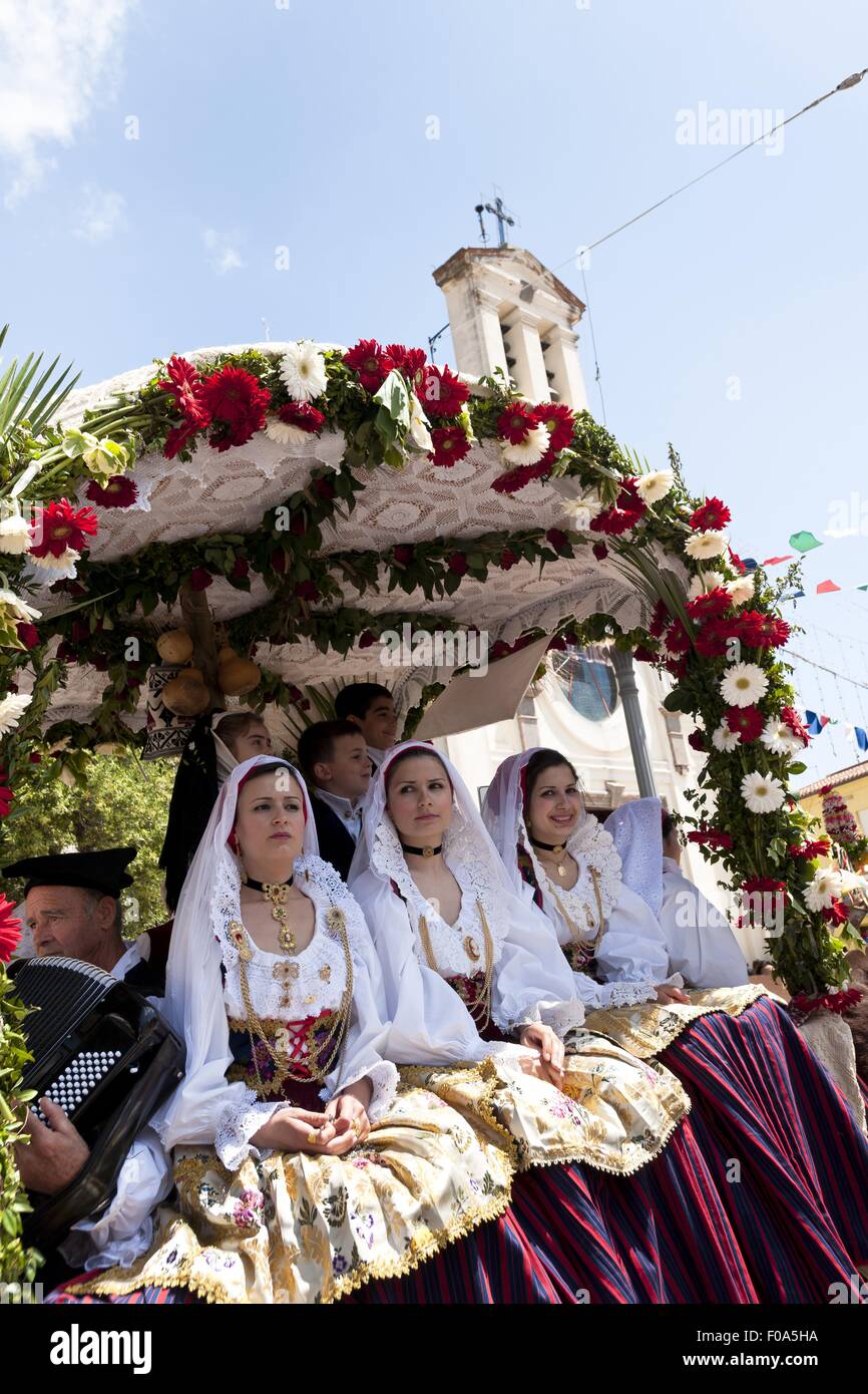 Women sitting in cart for Sant'Efisio procession, Pula, Sardinia, Italy ...