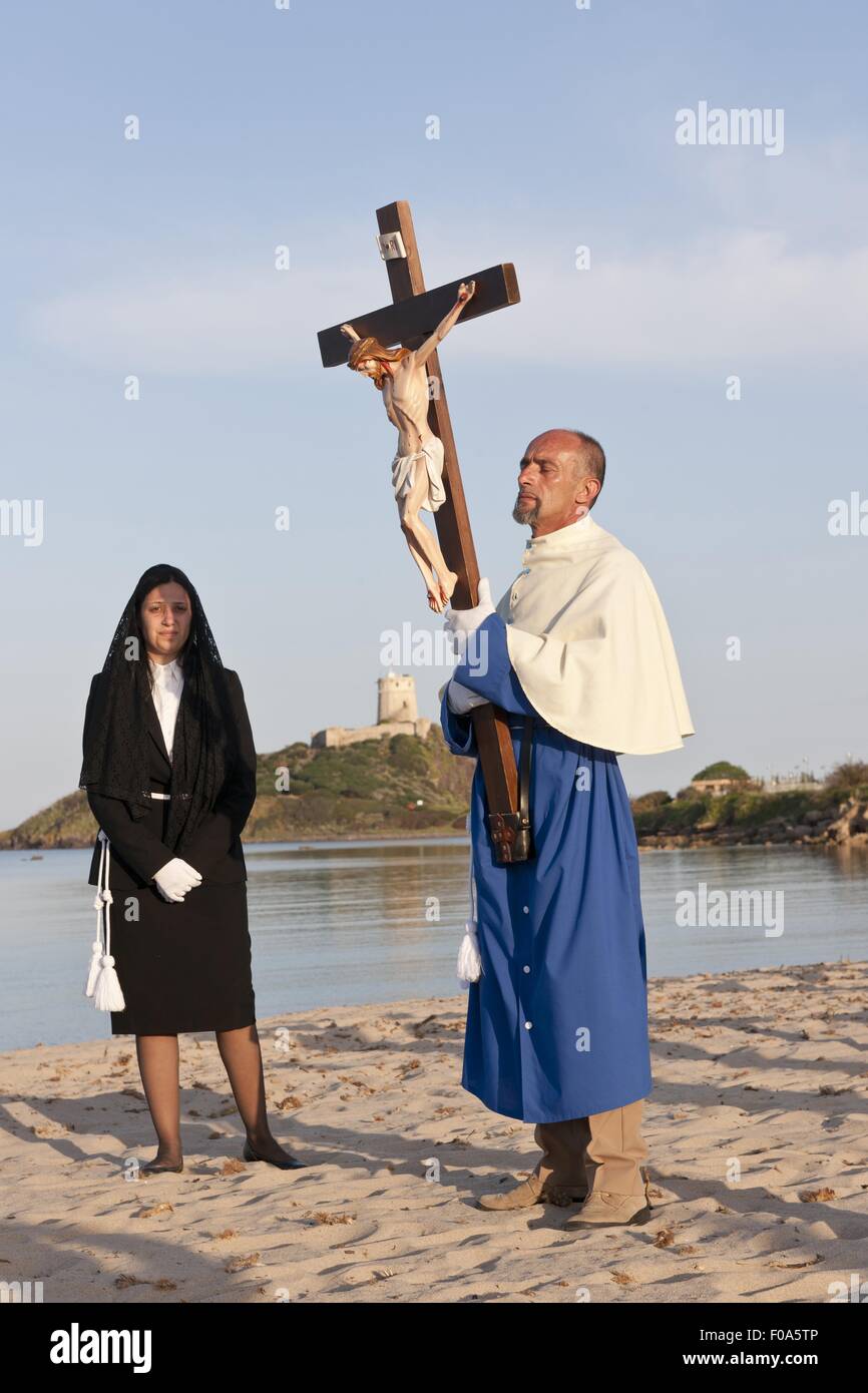 Priest holding cross and women walking in procession at Nora, Cagliari ...