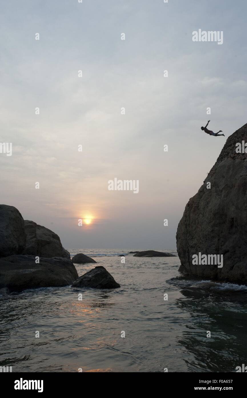 Person diving from rocks in sea at sunset, Sri Lanka Stock Photo - Alamy