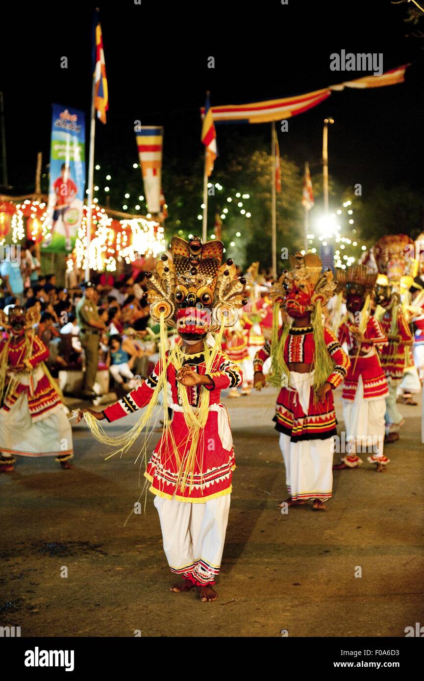 Dancer wearing masks at hard Navam Perahera procession, Colombo, Sri ...