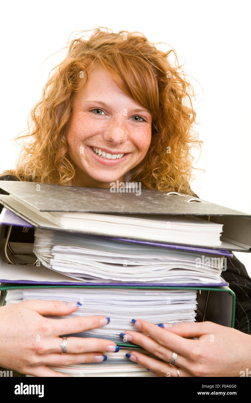 Young redhaired woman embracing files on her desk Stock Photo - Alamy