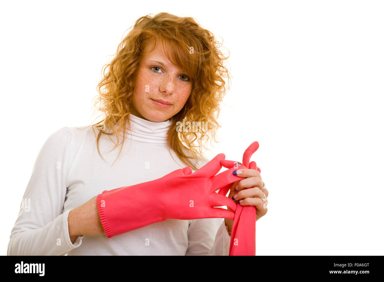 Young redhaired woman taking off plastic gloves Stock Photo - Alamy