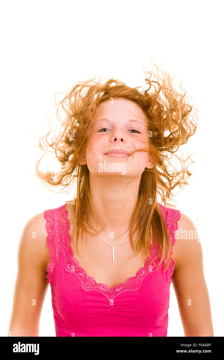 Young woman with long red curls letting her hair fly Stock Photo - Alamy