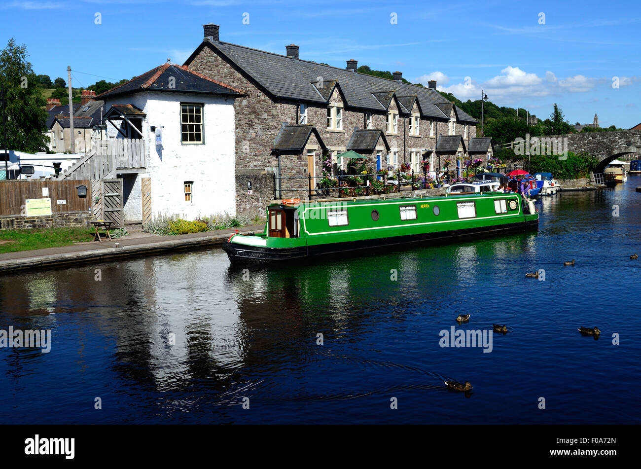 Green narrow boat on the Monmouthshire and Brecon Canal at Brecon Powys ...