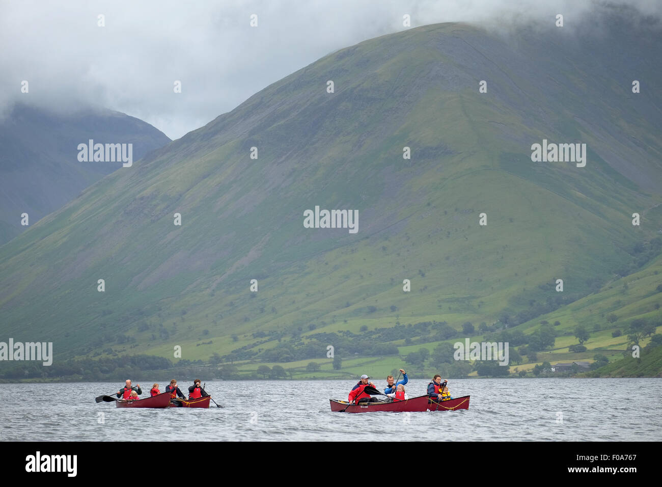 A group of people in canoe boats on Wastwater in the Lake District ...