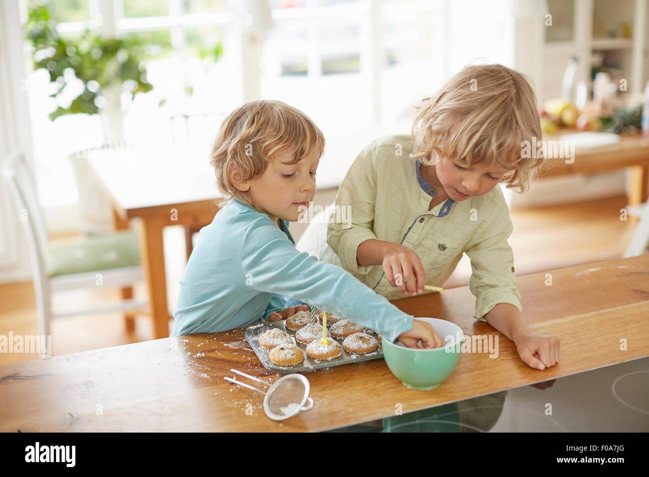 Boys making cupcakes in kitchen Stock Photo - Alamy
