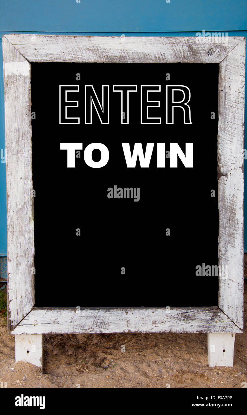 Enter To Win message written on vintage chalkboard, conceptual image ...