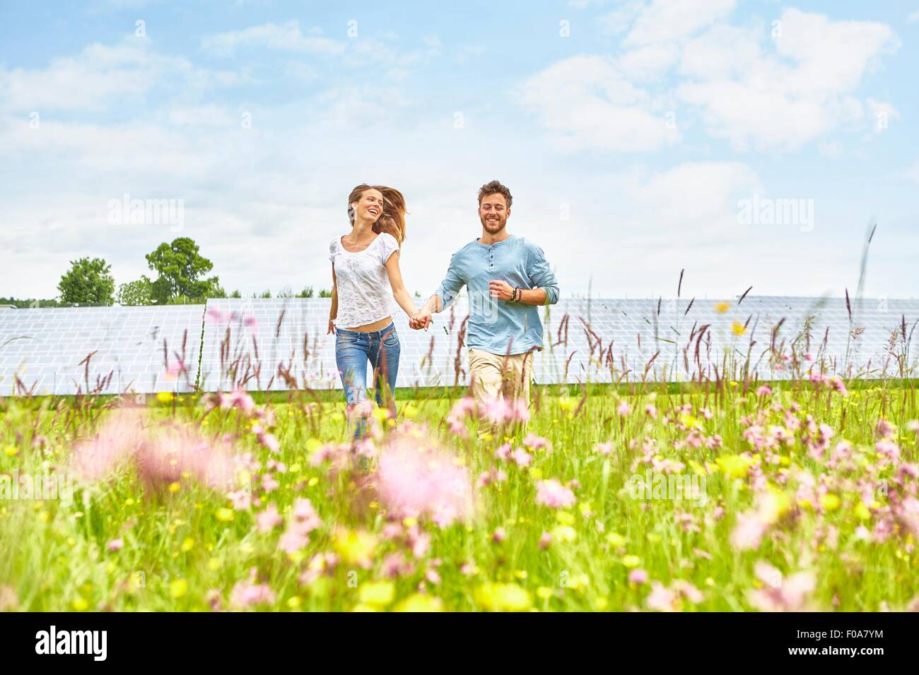 Running flower field people hi-res stock photography and images - Alamy