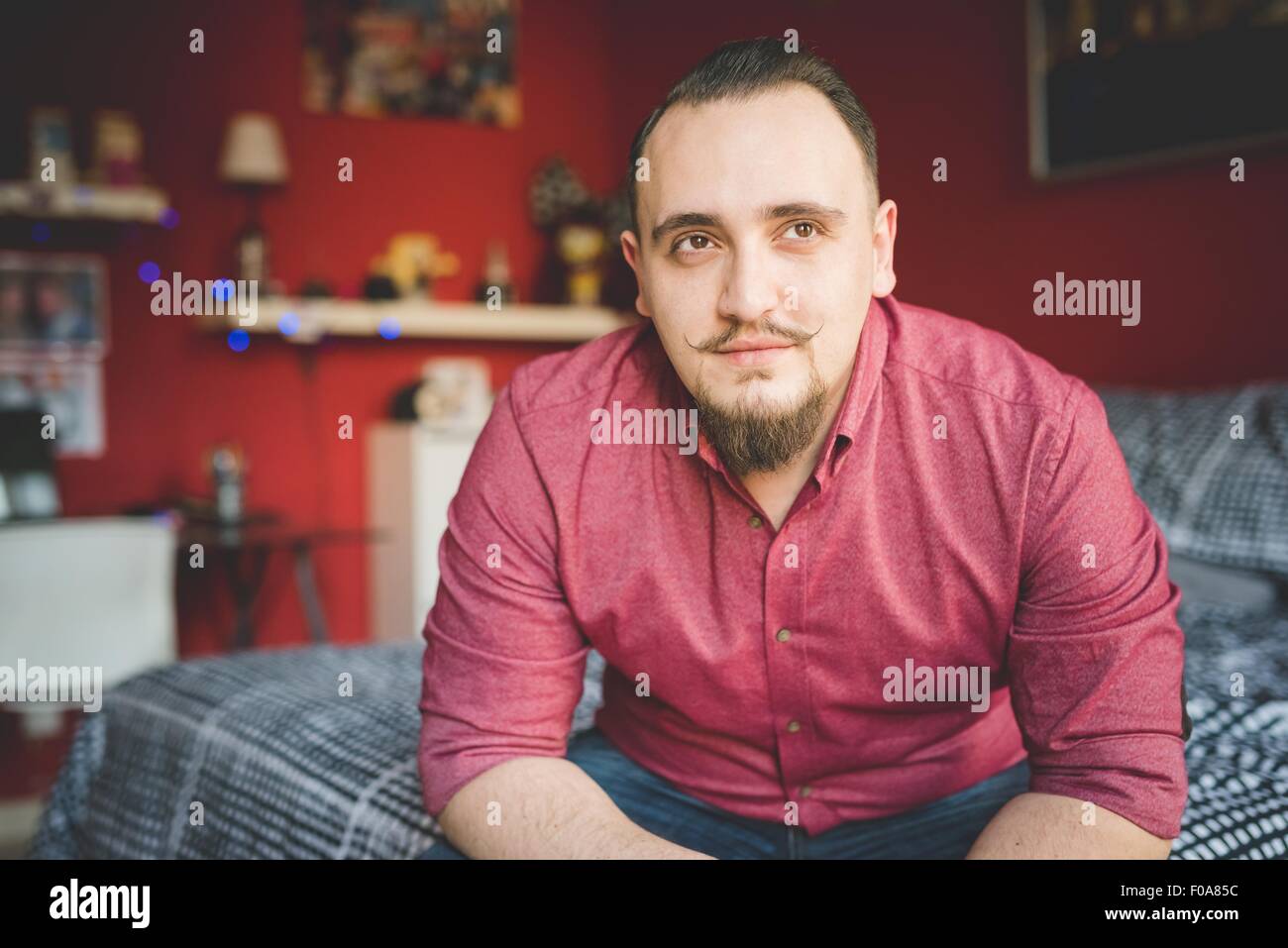 Portrait of young man in bedroom Stock Photo - Alamy