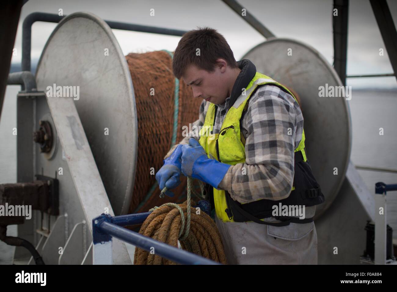 Fisherman preparing net reel Stock Photo - Alamy