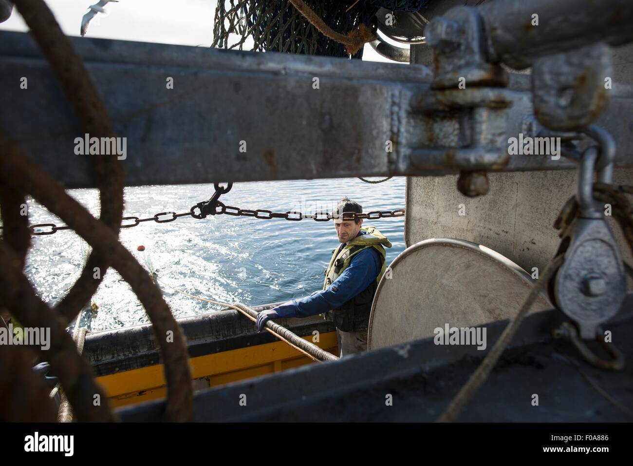 Fisherman preparing net reel Stock Photo - Alamy