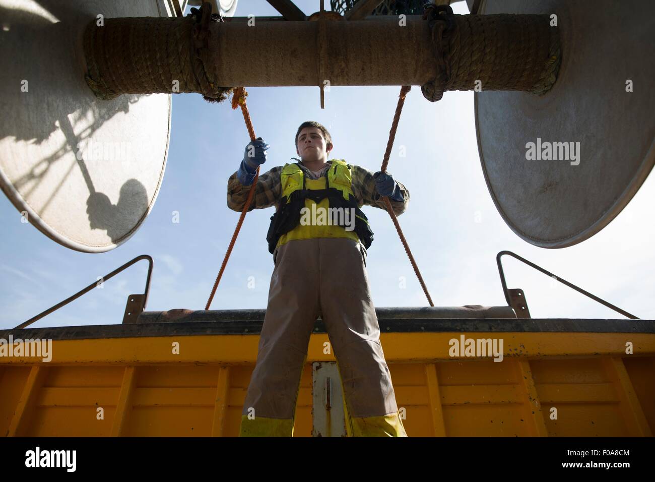 Fisherman reeling in net Stock Photo - Alamy