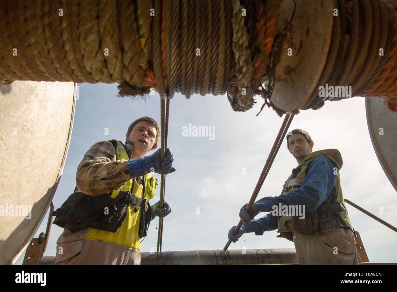 Fishermen reeling in net Stock Photo - Alamy