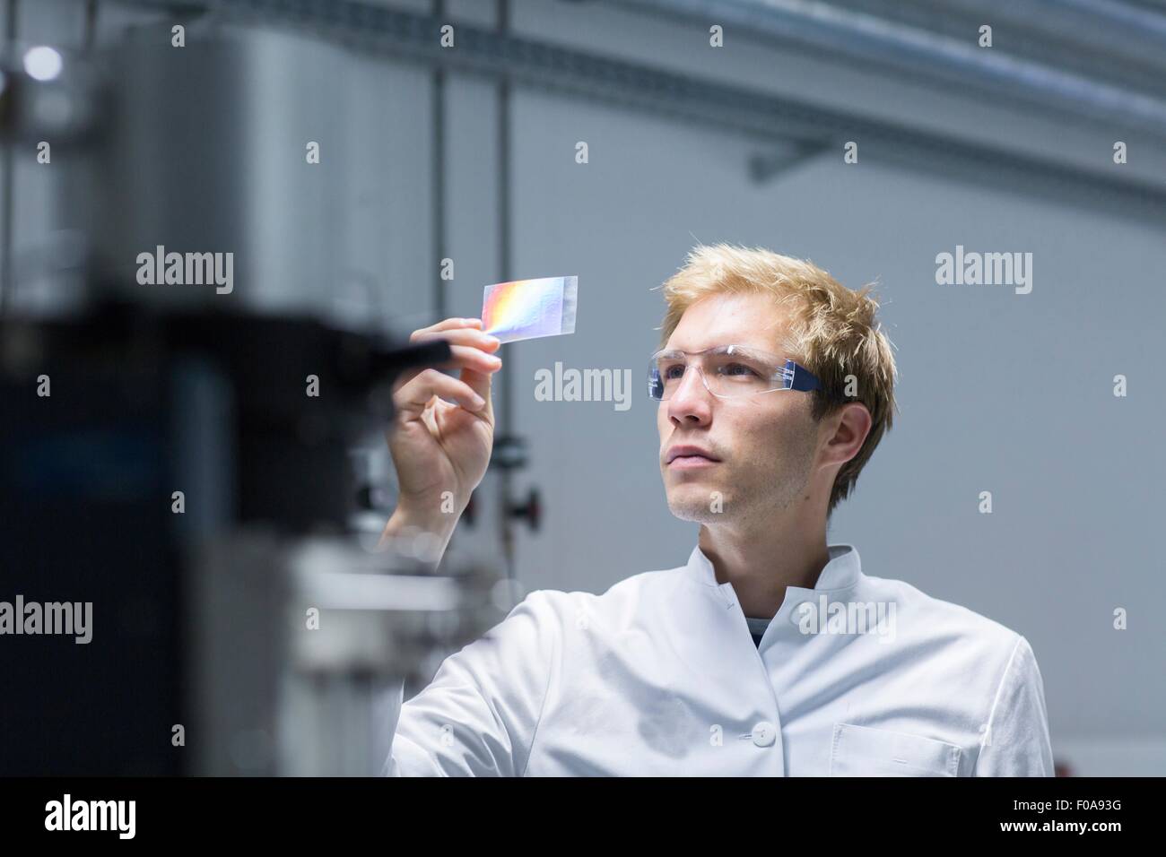 Male scientist analysing microscope slide in laboratory Stock Photo - Alamy