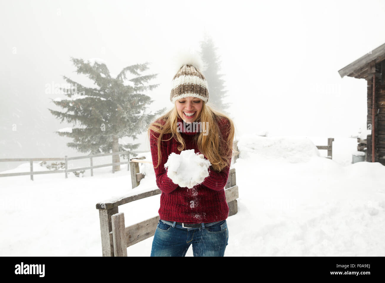 Young woman making a snowball Stock Photo - Alamy