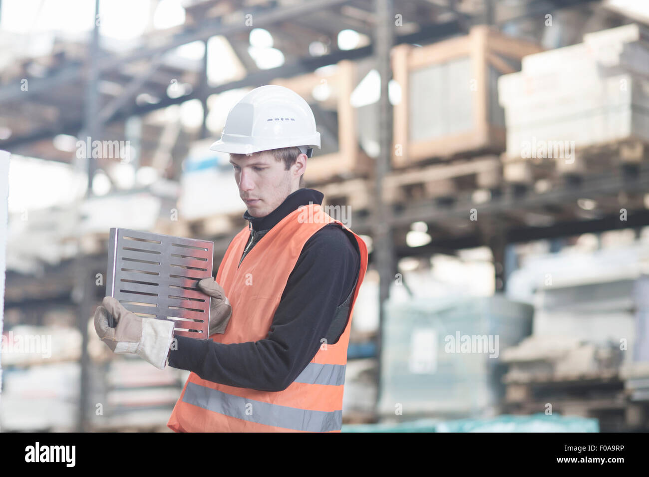 Young male warehouse worker steel product in warehouse Stock Photo - Alamy