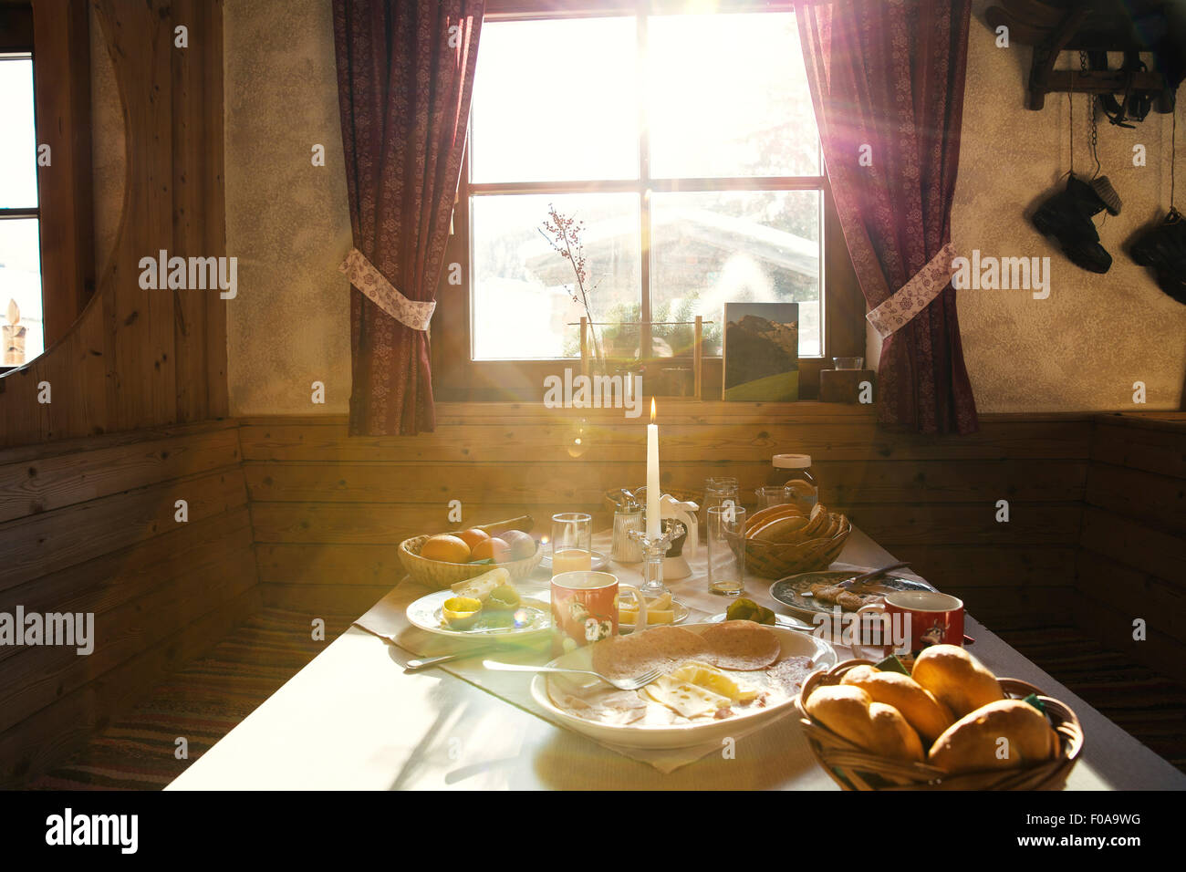 Sunlit breakfast table in log cabin Stock Photo - Alamy