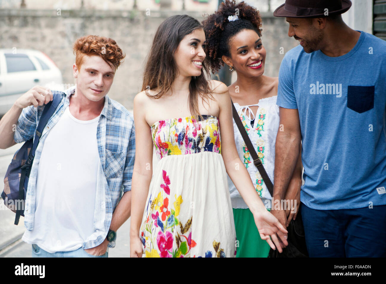 Friends smiling together on city street hi-res stock photography and ...