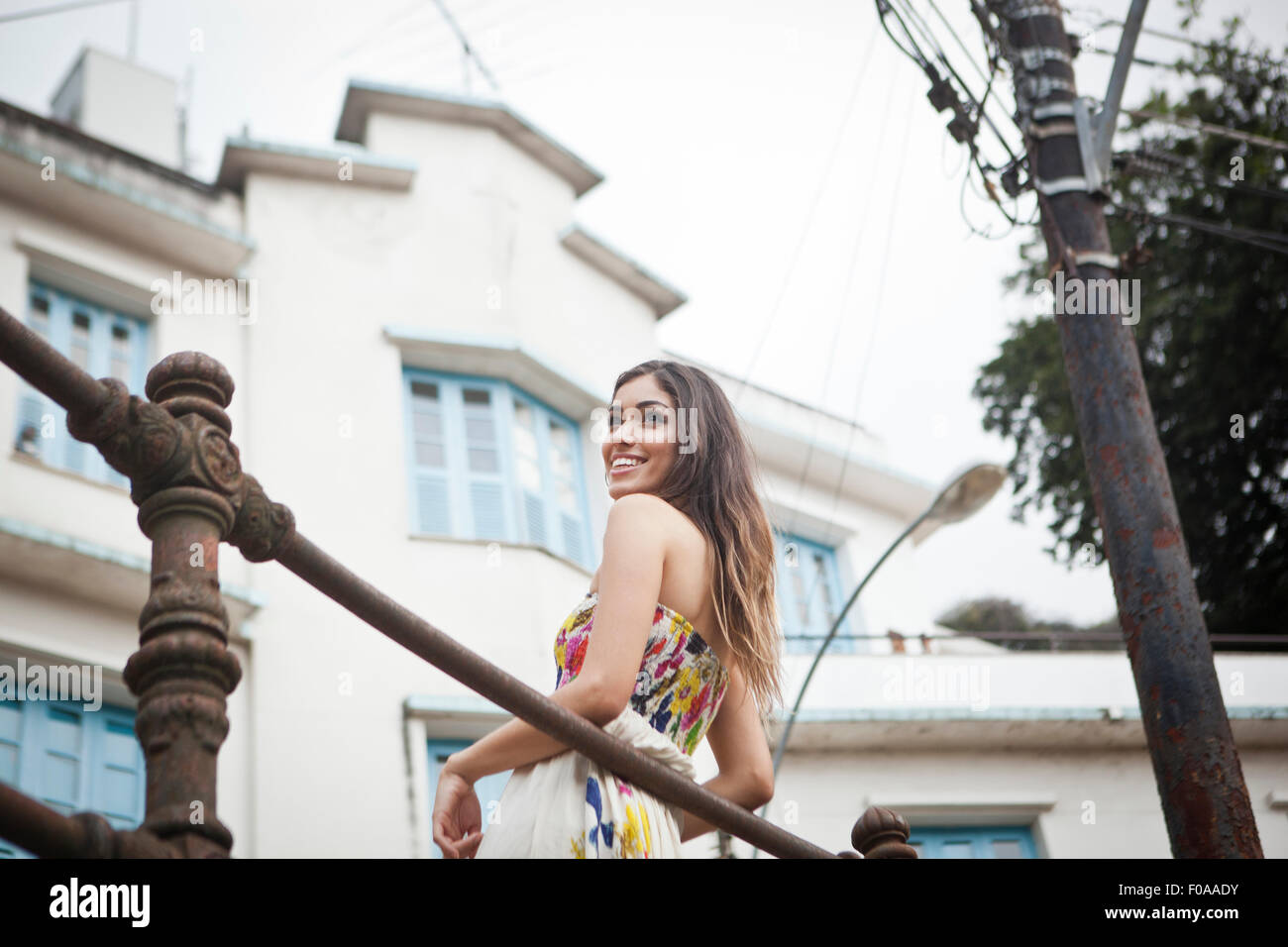 Woman leaning against rail hi-res stock photography and images - Alamy