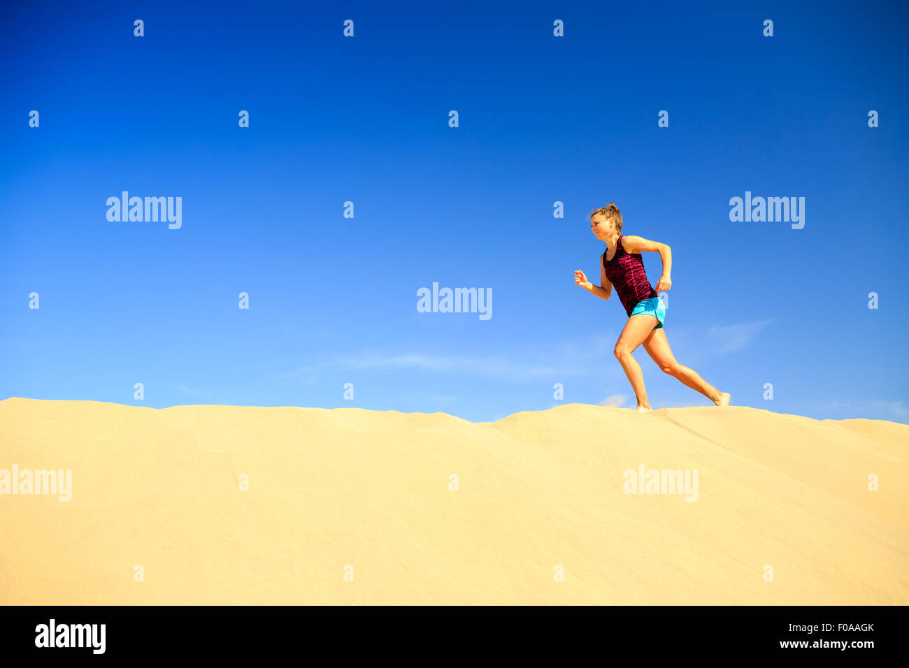 Young woman running on beautiful inspirational desert dunes on sunny ...