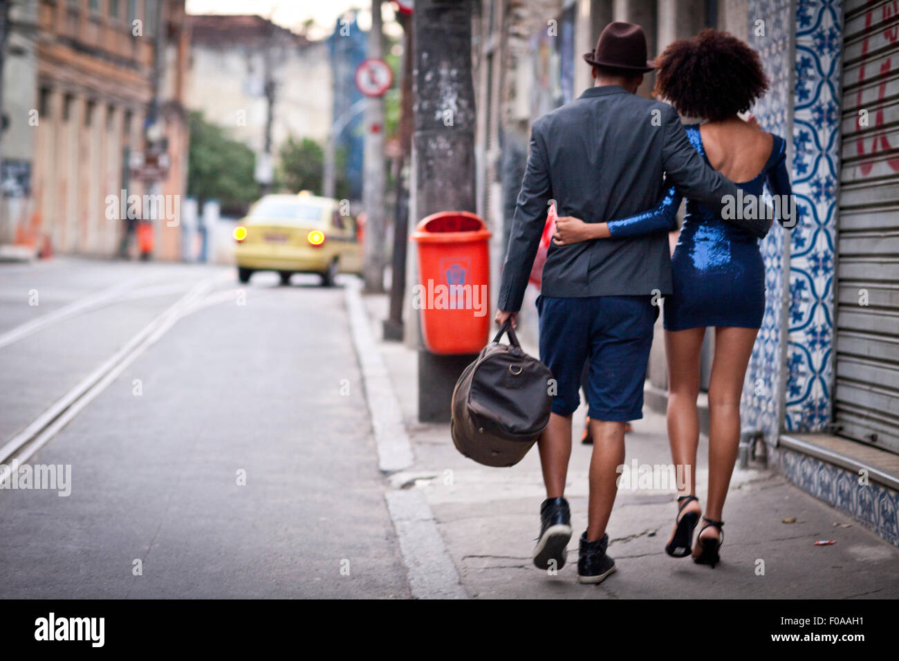 Couple walking along street together, rear view Stock Photo - Alamy