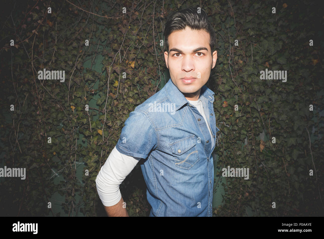 Portrait of a young man looking at camera Stock Photo - Alamy
