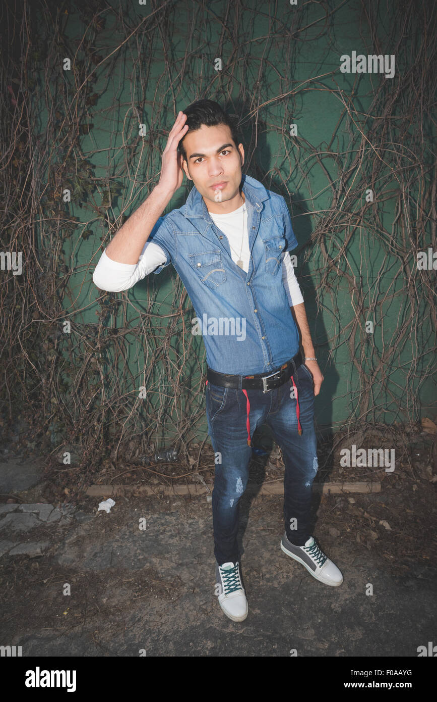 Stylish young man with hand in hair Stock Photo - Alamy