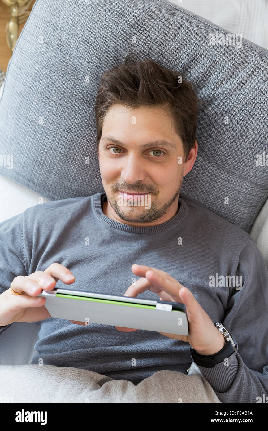 Man using digital tablet on bed Stock Photo - Alamy