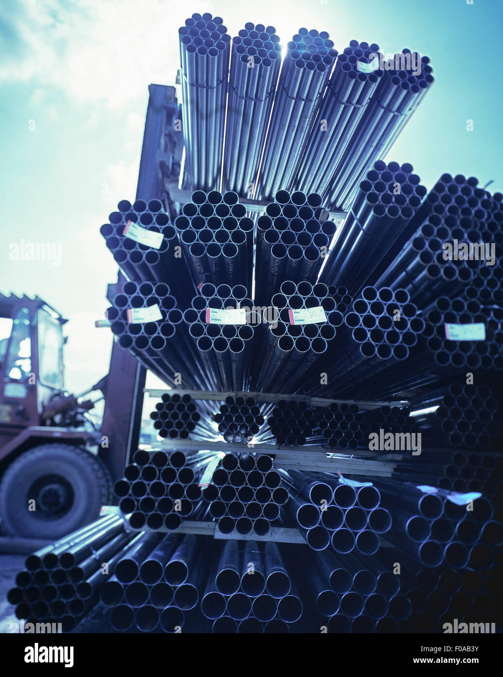 Forklift truck moving steel pipes in port, Grimsby, England, United ...
