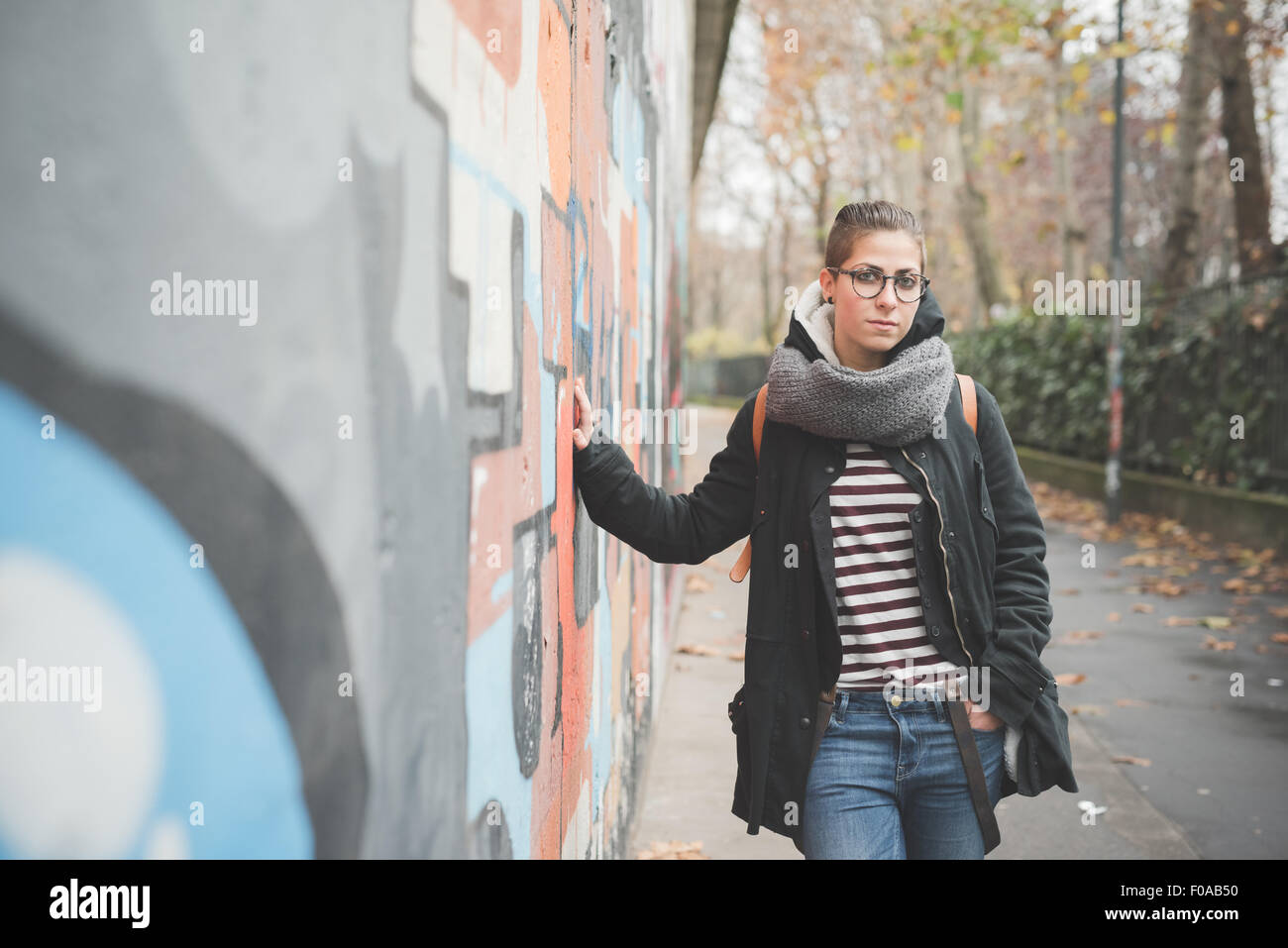 Leaning against graffiti wall hi-res stock photography and images - Alamy