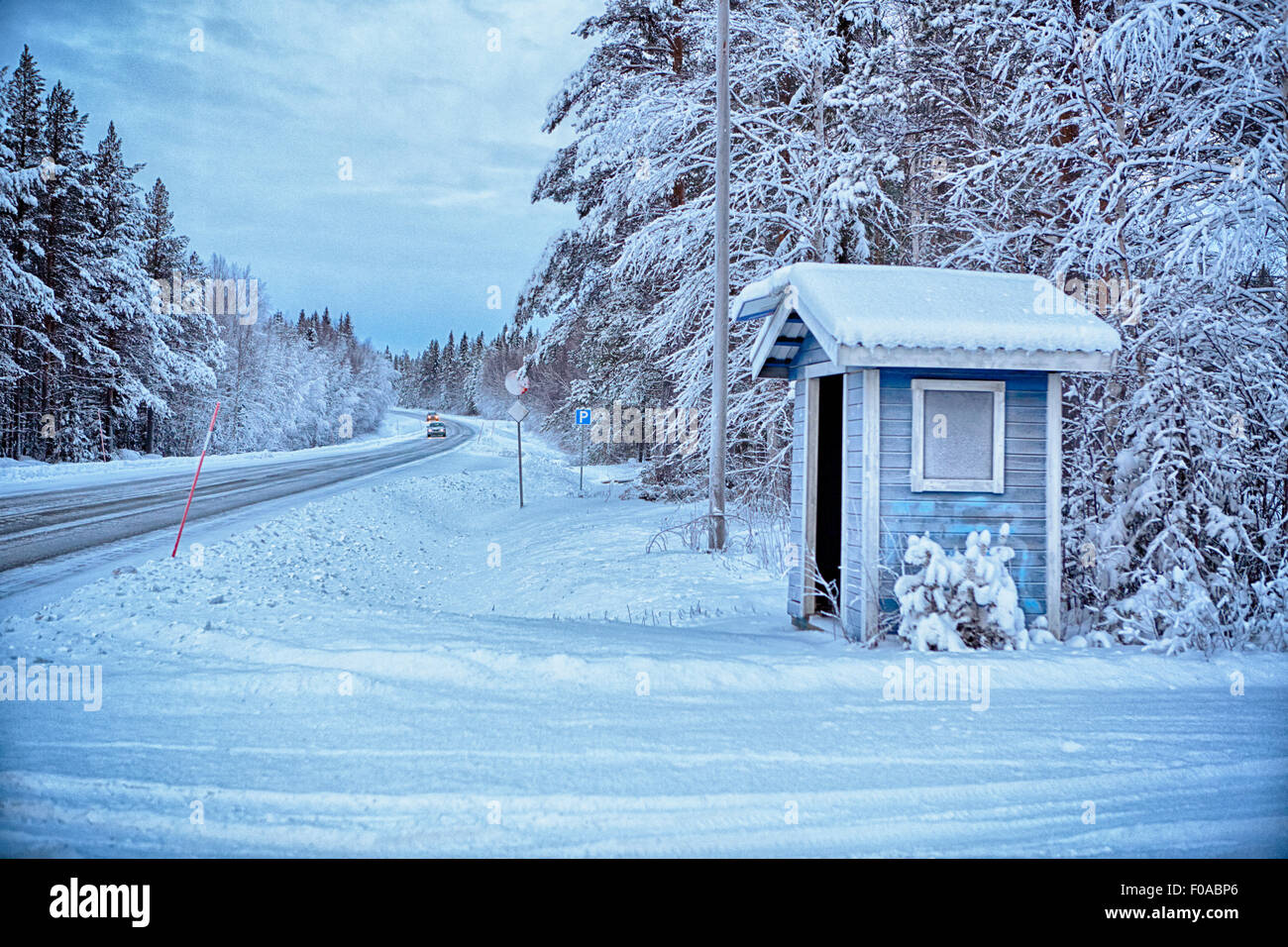 Traditional bus stop on corner of snow covered rural road, Hemavan ...