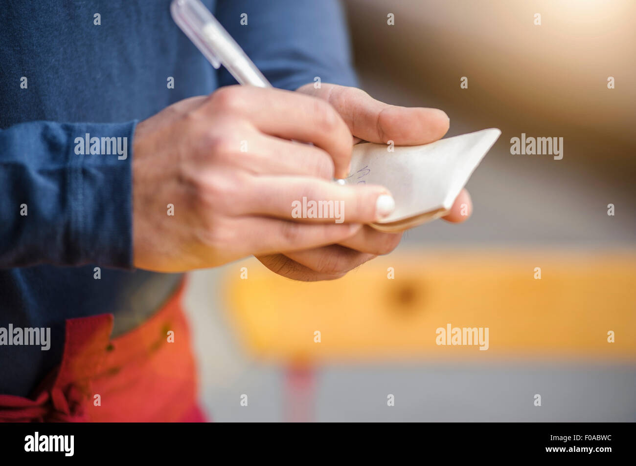 Waiters hands taking order, cropped Stock Photo - Alamy