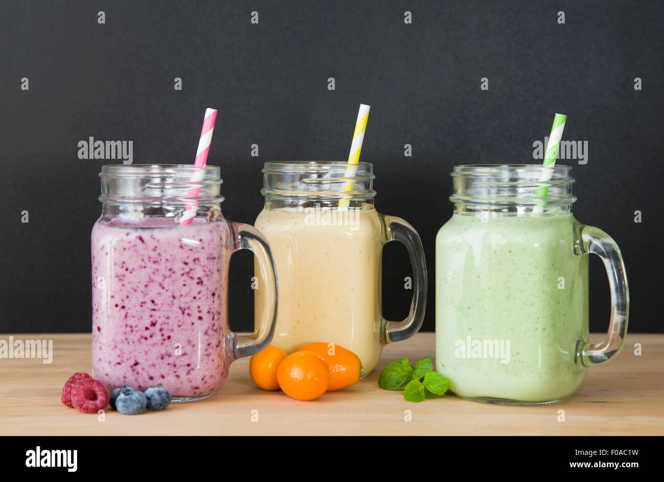 Still life of three fresh smoothies and fruit Stock Photo - Alamy