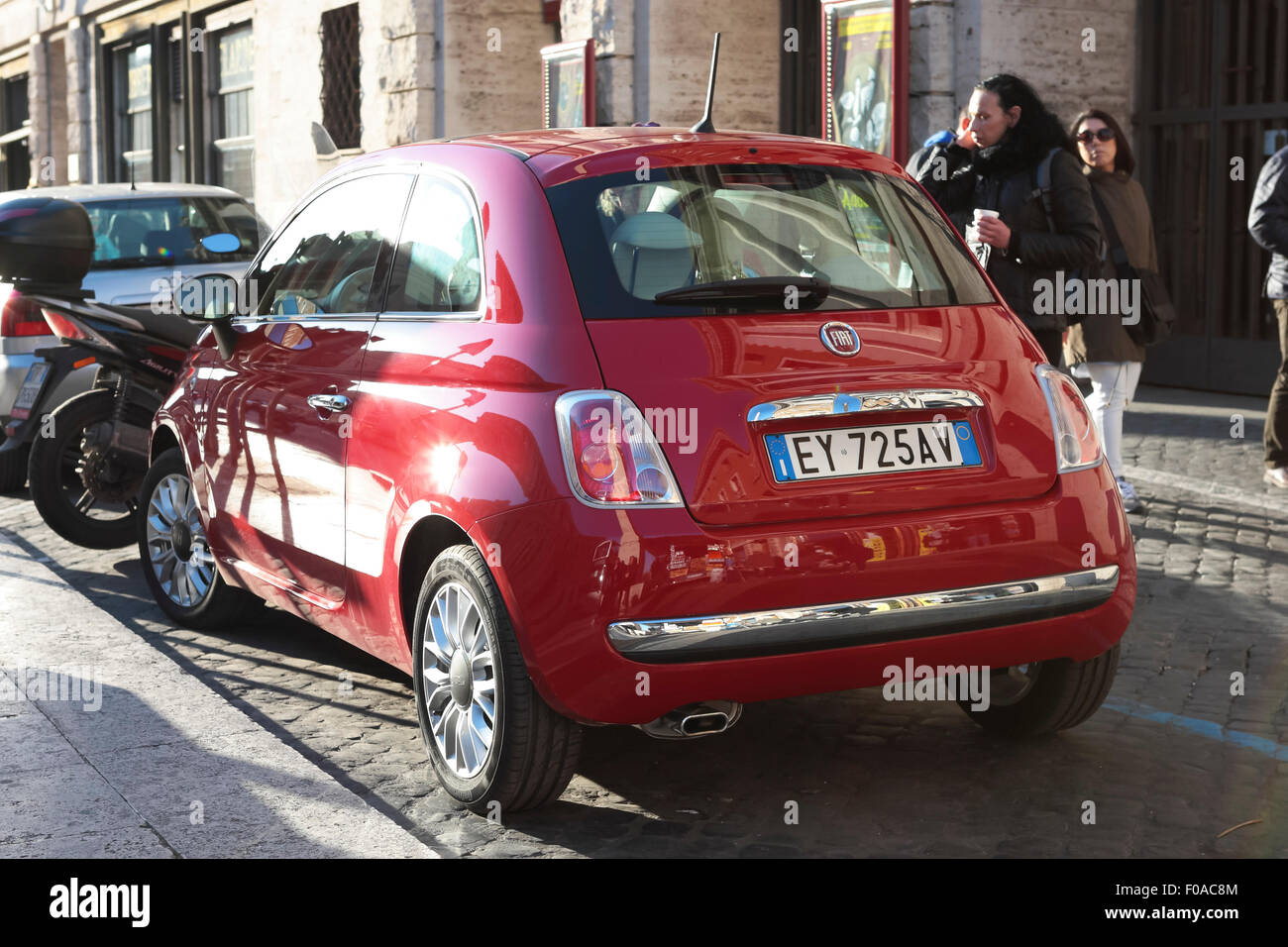Italian icon. Bright red Fiat 500 Cinquecento car parked close to ...