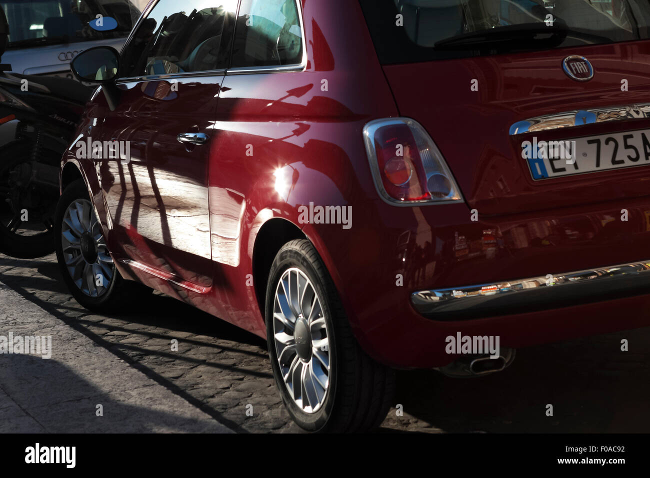 Italian icon. Bright red Fiat 500 Cinquecento car parked close to ...