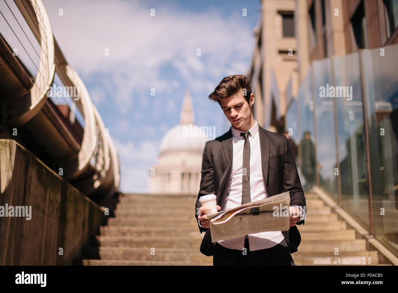 Young Man Walking Reading Newspaper High Resolution Stock Photography ...