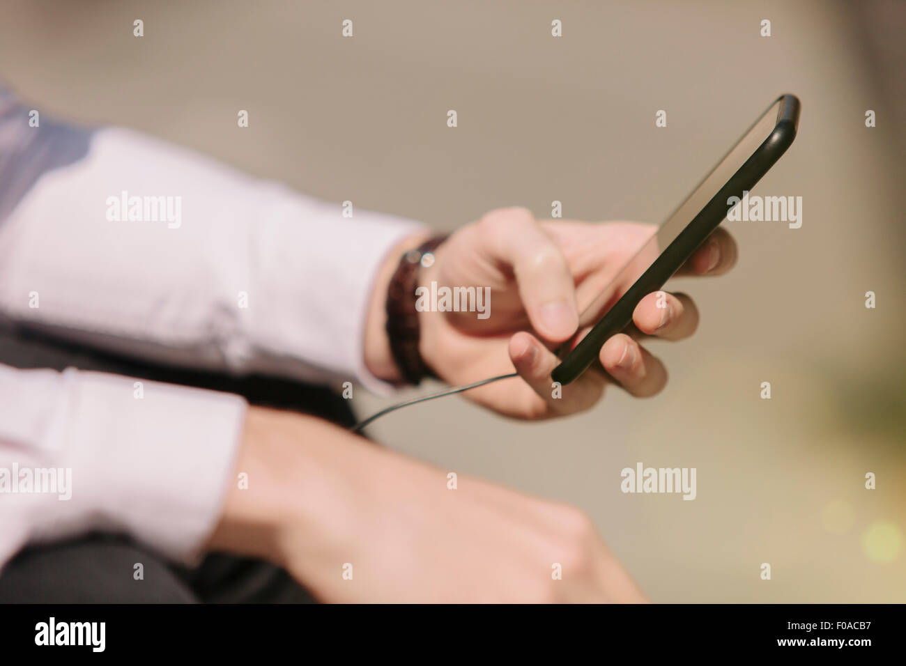 Hands of young businessman selecting music on smartphone Stock Photo ...