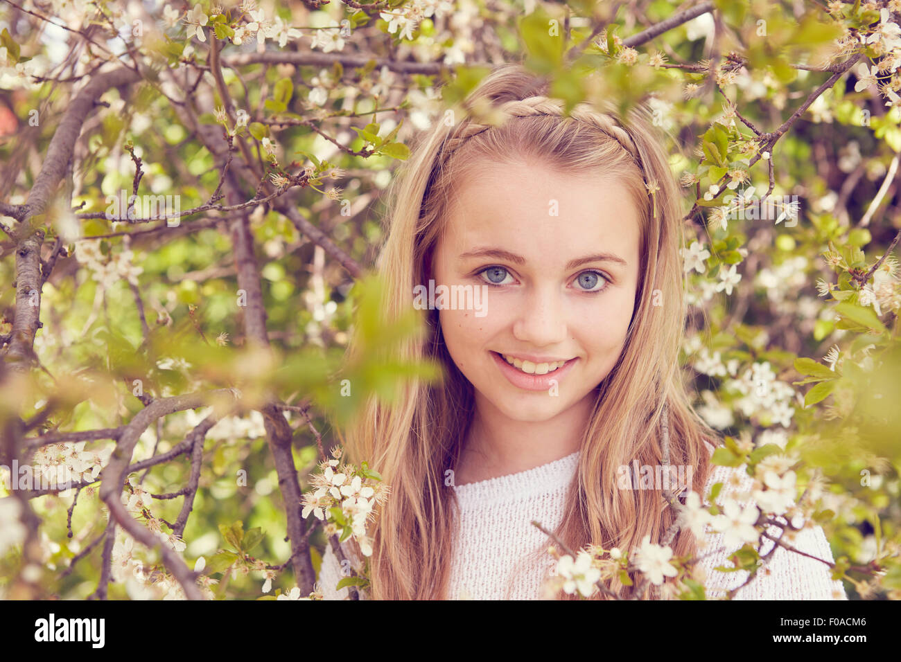 Portrait of pretty girl and tree blossom Stock Photo - Alamy